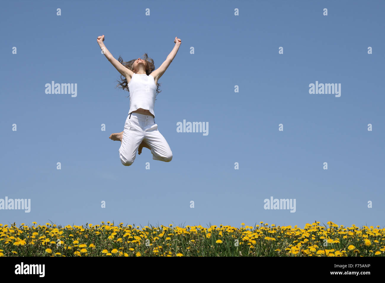 Girl in a jump, looking up Stock Photo - Alamy