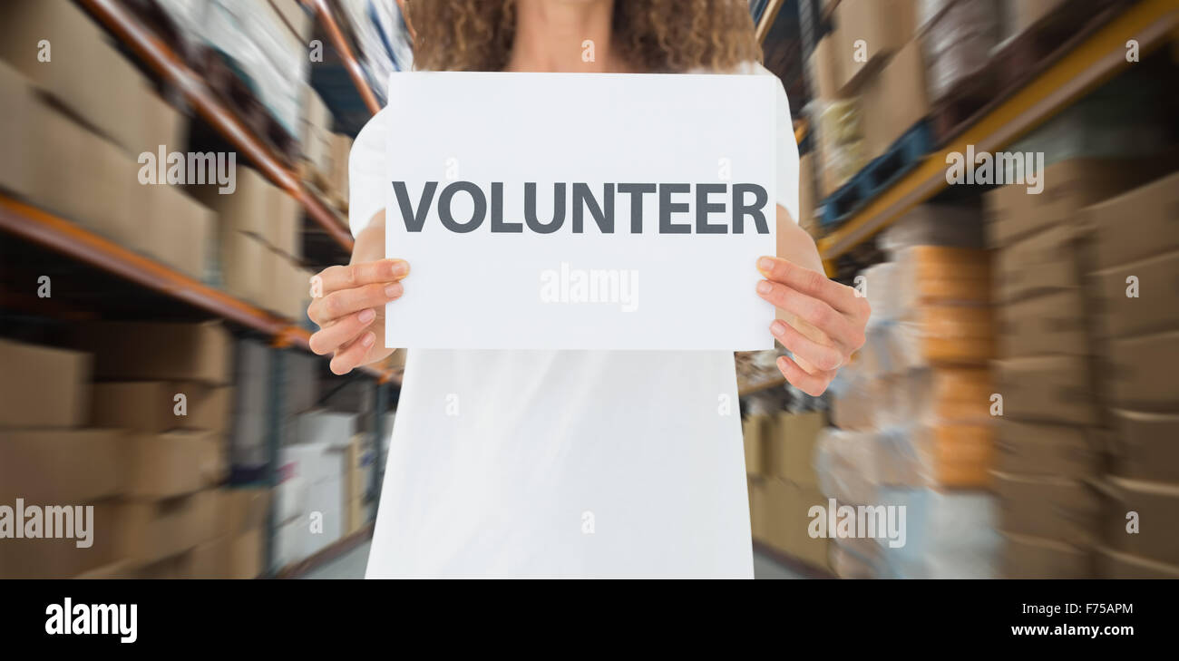 Composite image of volunteer showing a poster Stock Photo - Alamy