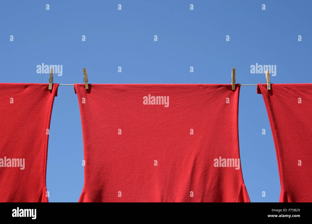 Red t-shirts on a clothes-line Stock Photo - Alamy