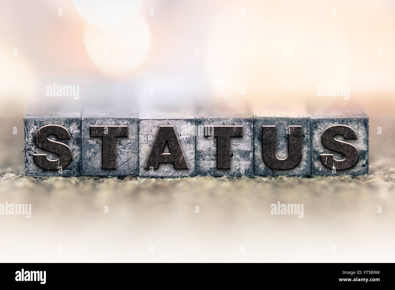 The word "STATUS" written in vintage ink stained letterpress type Stock ...
