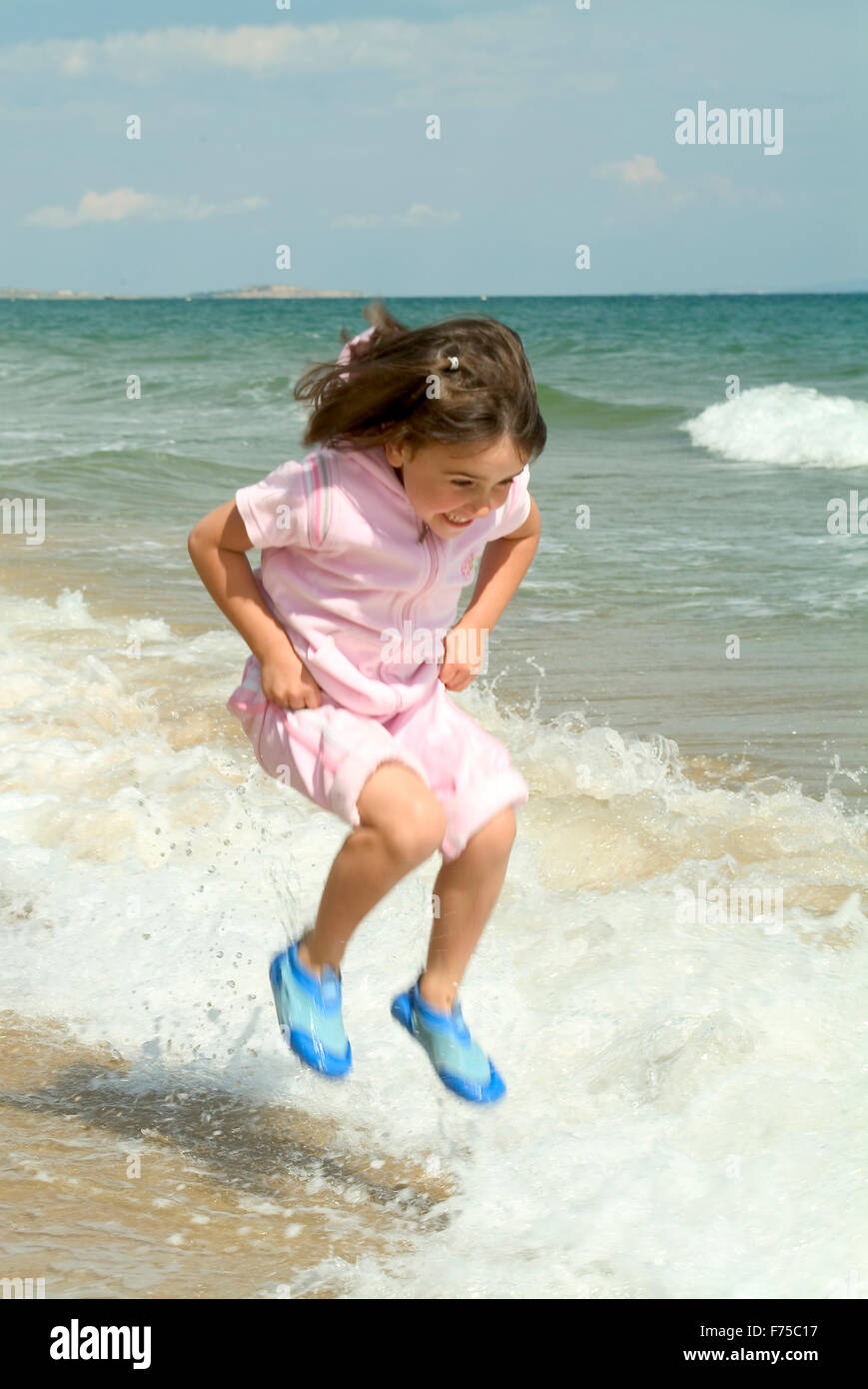 Child jumping over waves hi-res stock photography and images - Alamy