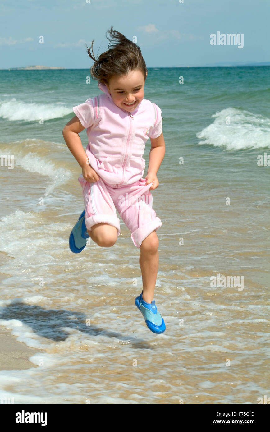Child jumping over waves hi-res stock photography and images - Alamy