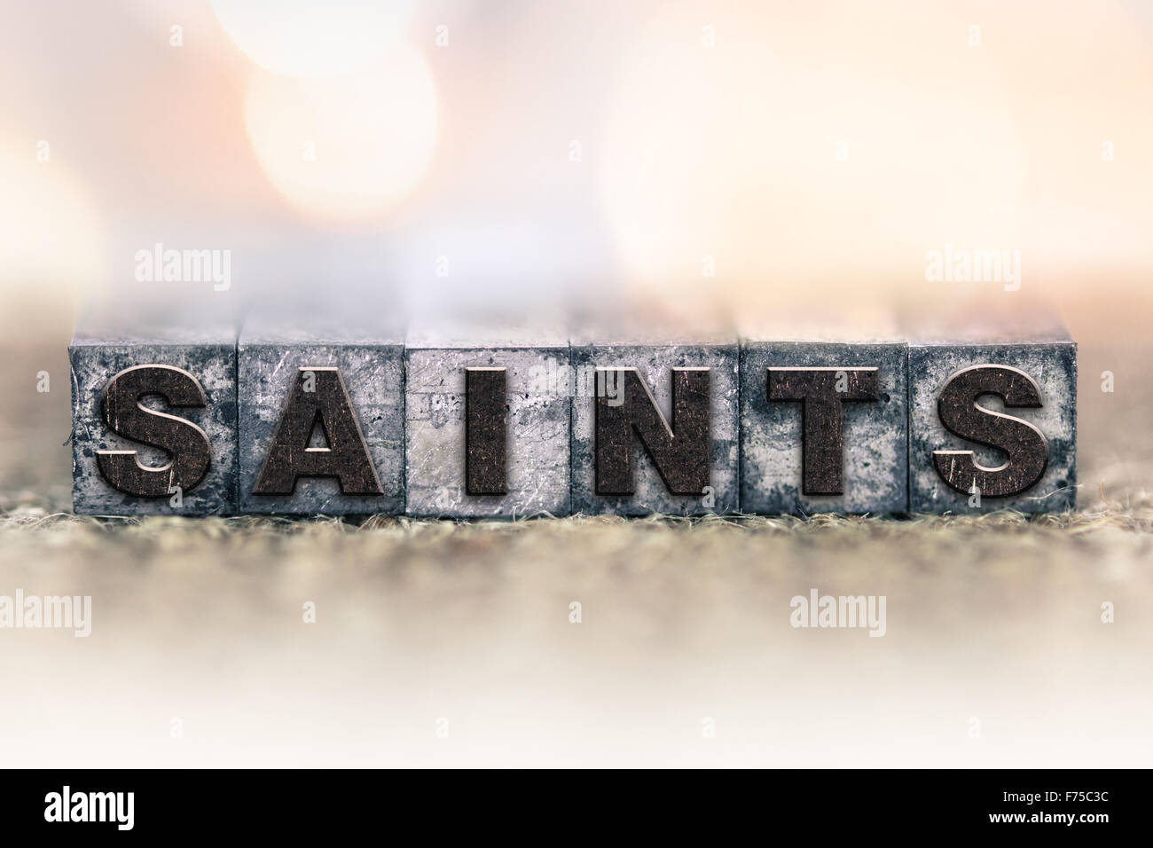The word "SAINTS" written in vintage ink stained letterpress type Stock ...