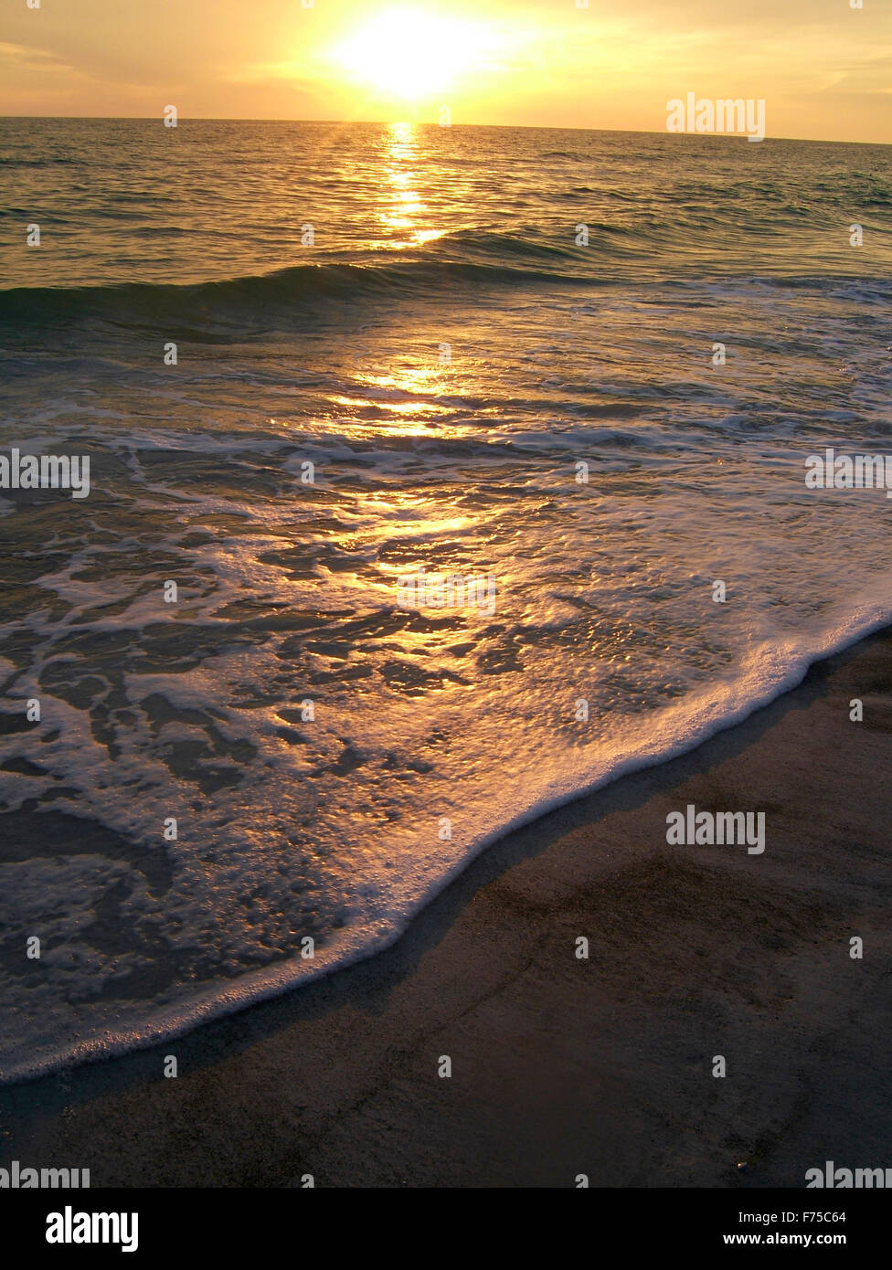 sun setting over sea Stock Photo - Alamy