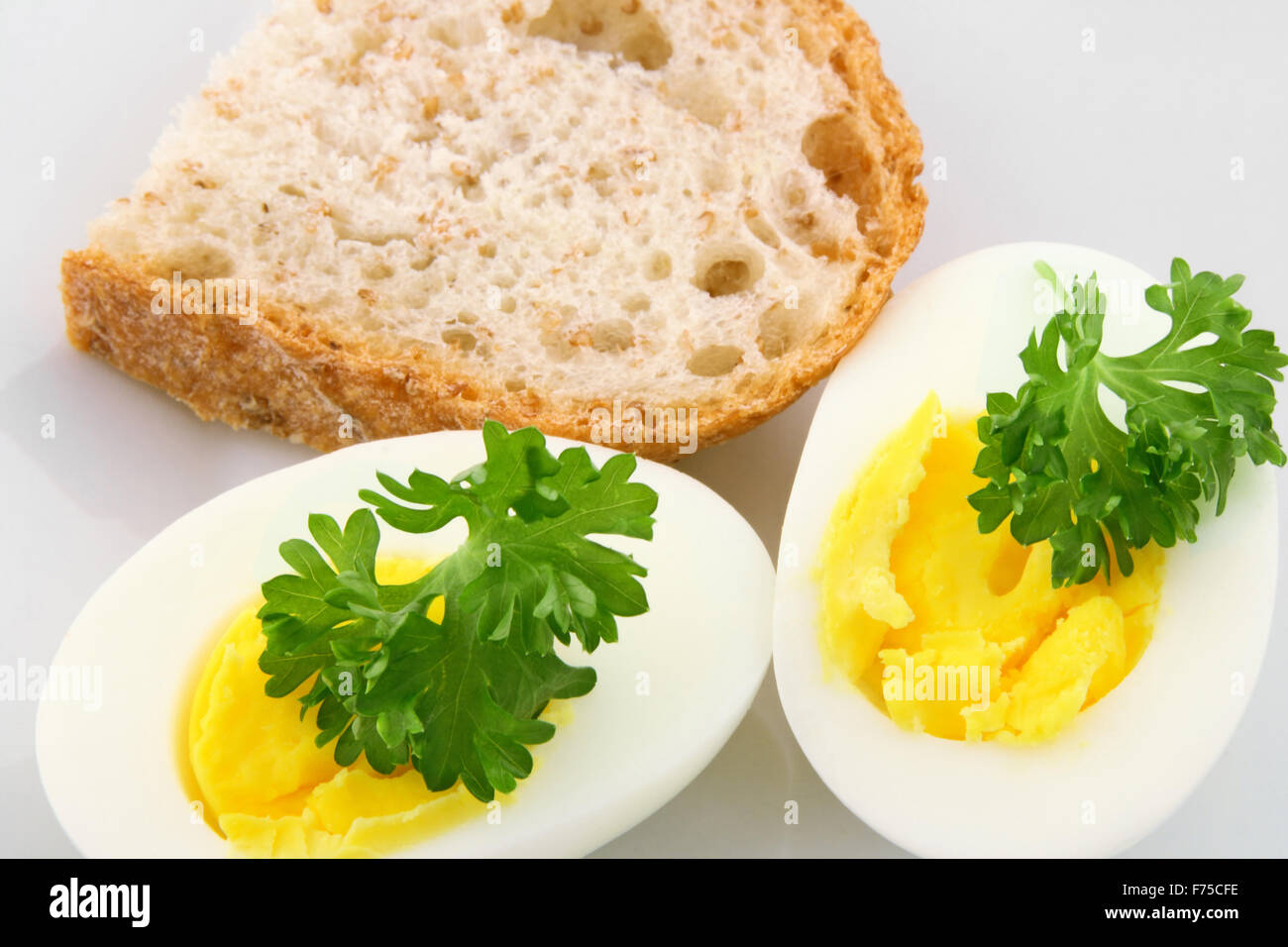 Cooked eggs decorated with parsley Stock Photo - Alamy