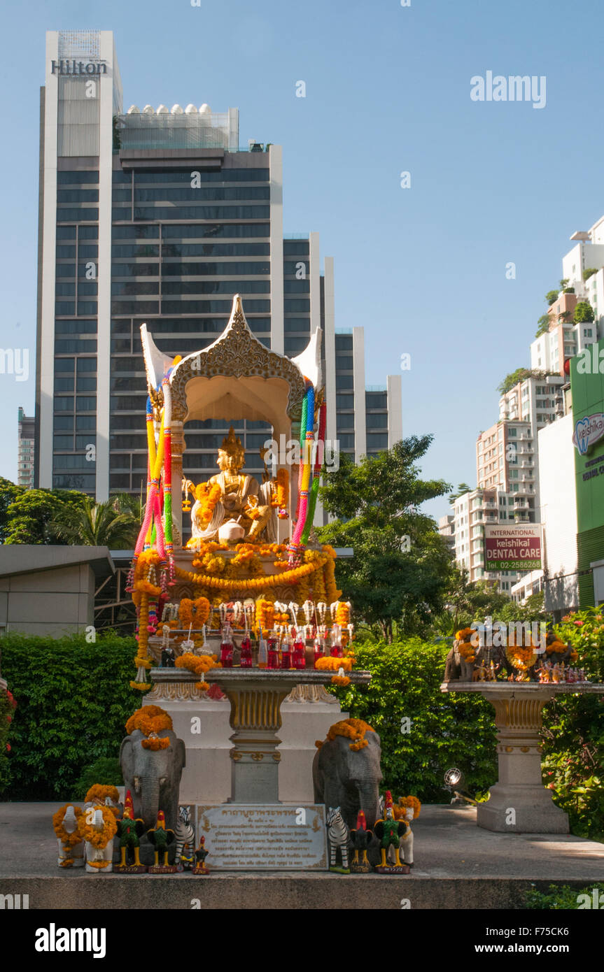Traditional shrine to a Hindu deity stands below an international ...
