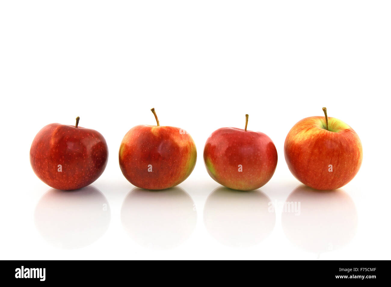 Four red apples in a row Stock Photo - Alamy