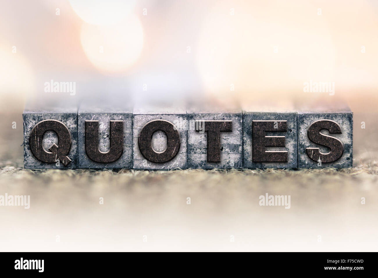 The word "QUOTES" written in vintage ink stained letterpress type Stock ...