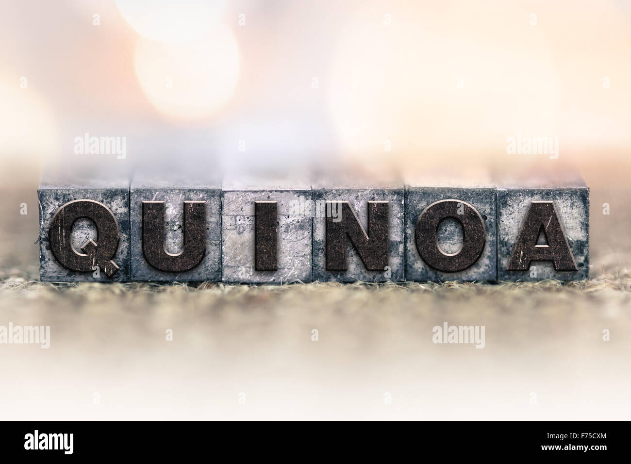 The word "QUINOA" written in vintage ink stained letterpress type Stock ...