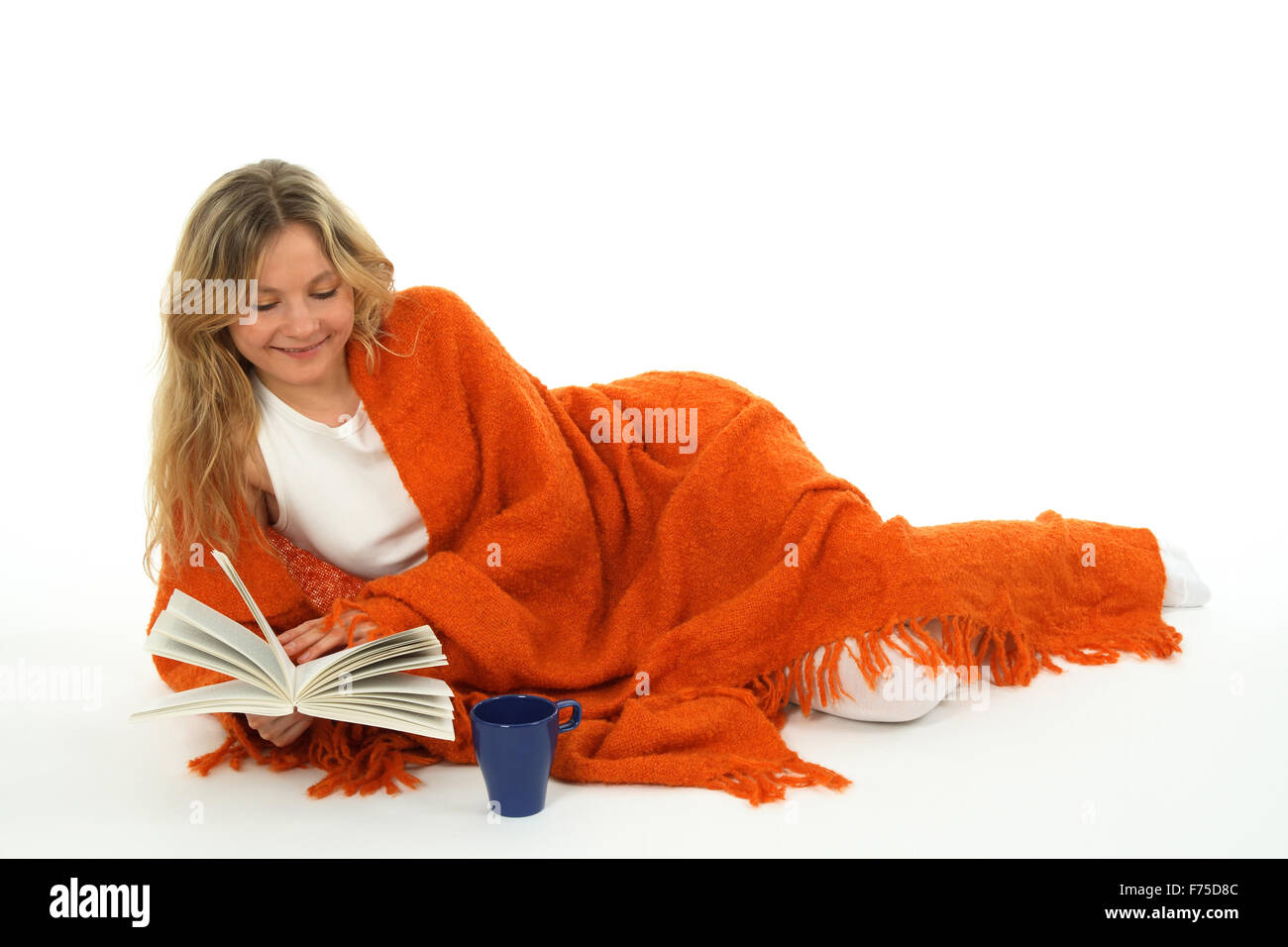 Cozy girl reading a book, smiling Stock Photo - Alamy