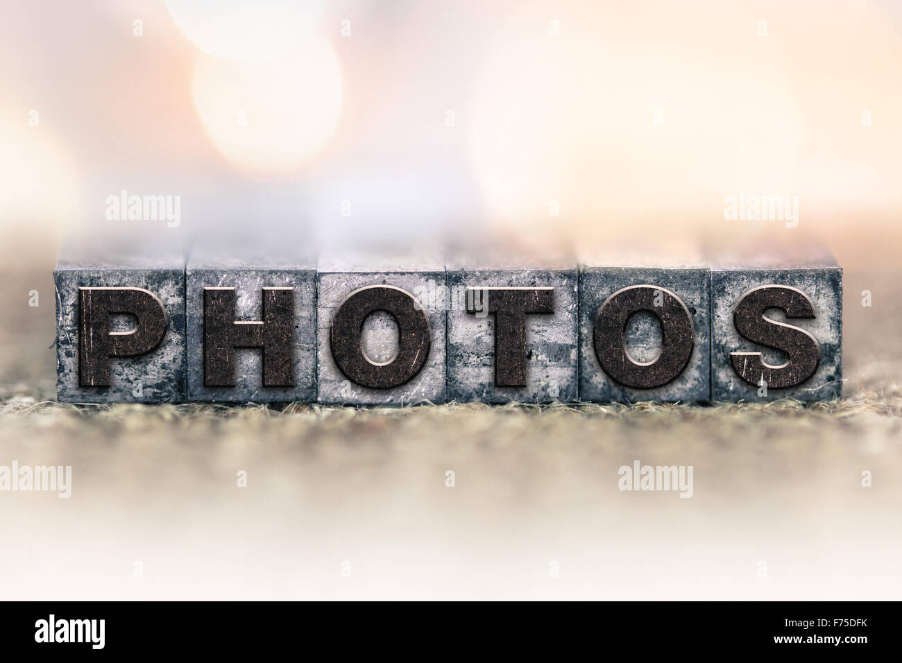 The word "PHOTOS" written in vintage ink stained letterpress type Stock ...