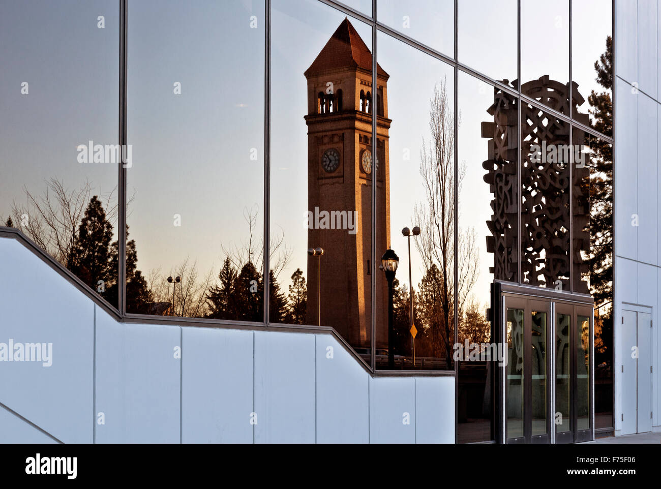 The Spokane Clock Tower reflecting at sunset in the glass windows of ...