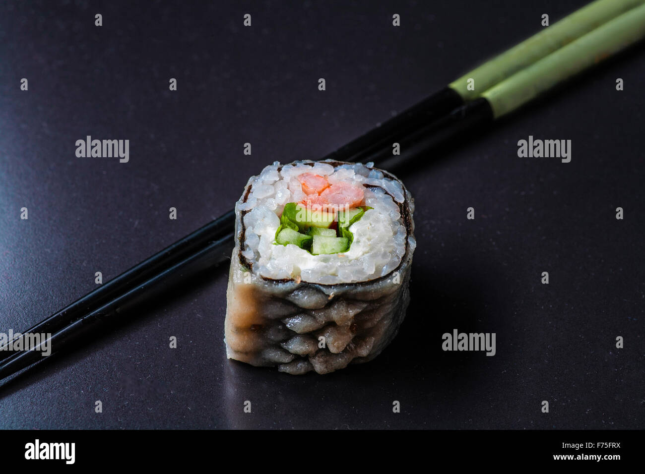 Maki sushi served on black background with reflection Stock Photo - Alamy
