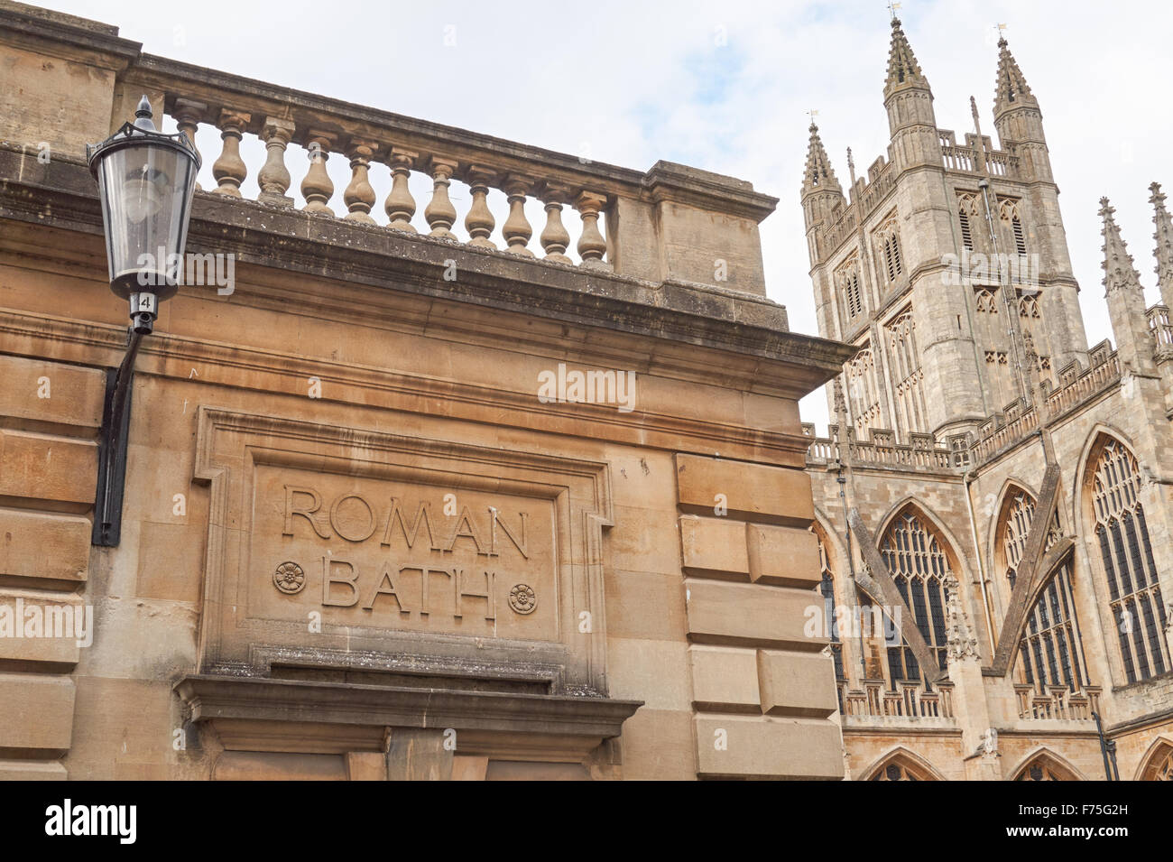 Stone carved sign at the Roman Baths with the Bath Abbey in the ...