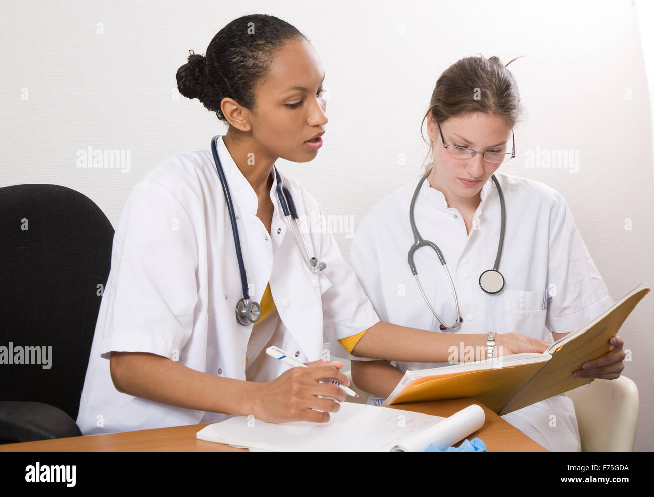 Doctor checking medical notes hi-res stock photography and images - Alamy
