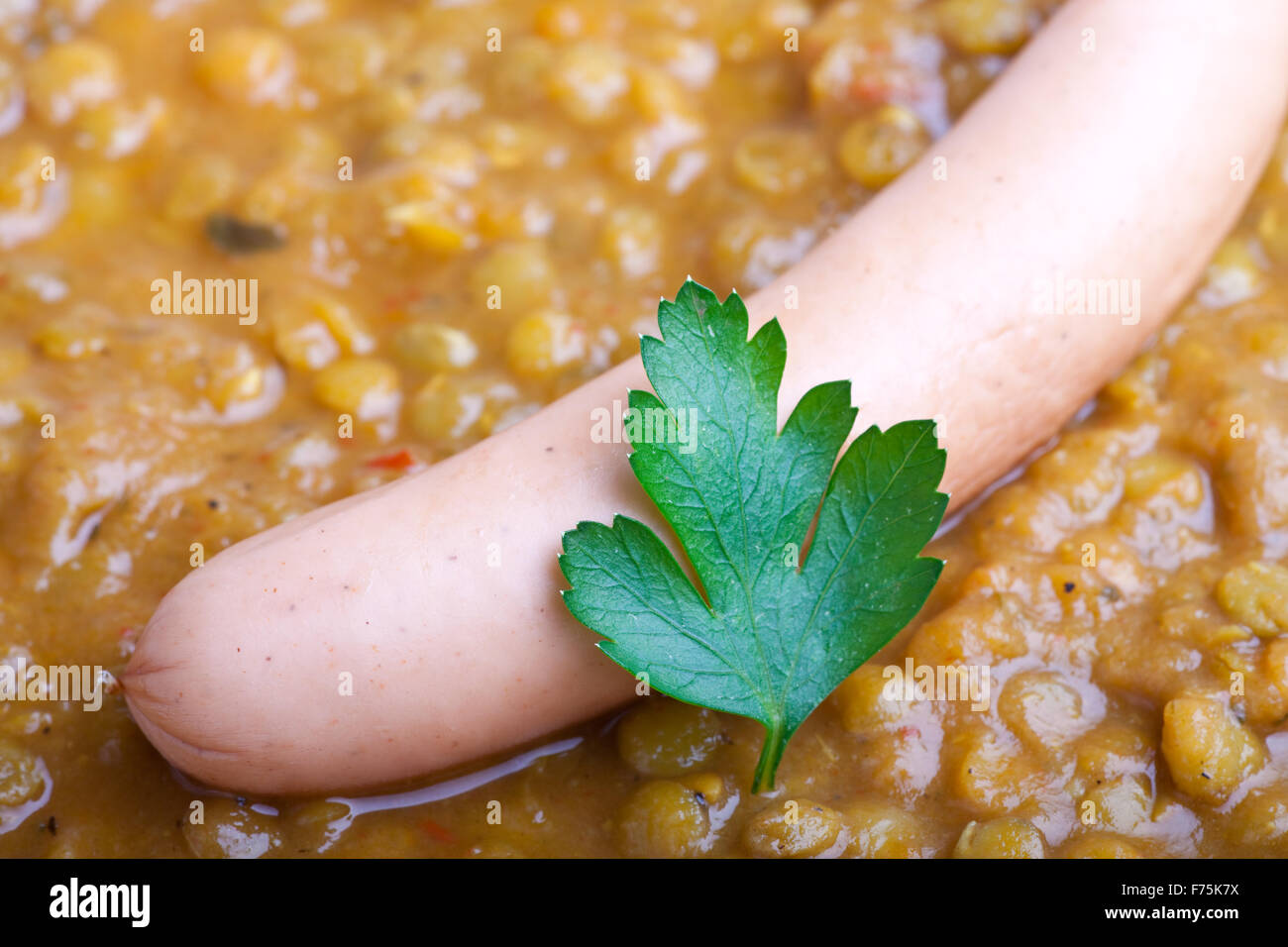 single wiener on a bed on beans Stock Photo - Alamy