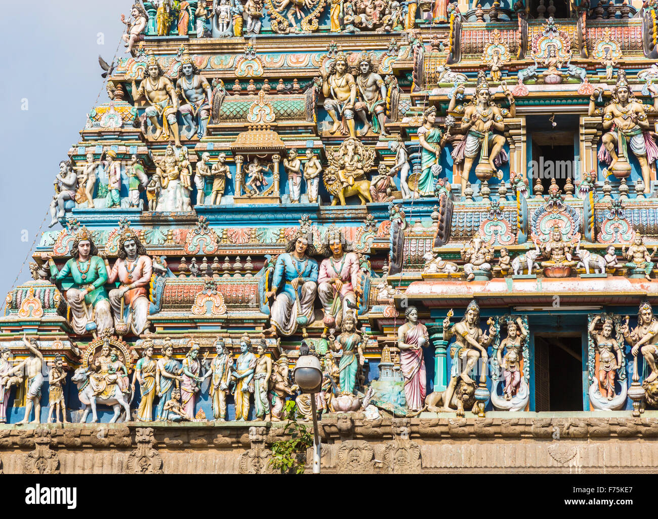 Traditional colourful carvings of Hindu deities on the facade of ...