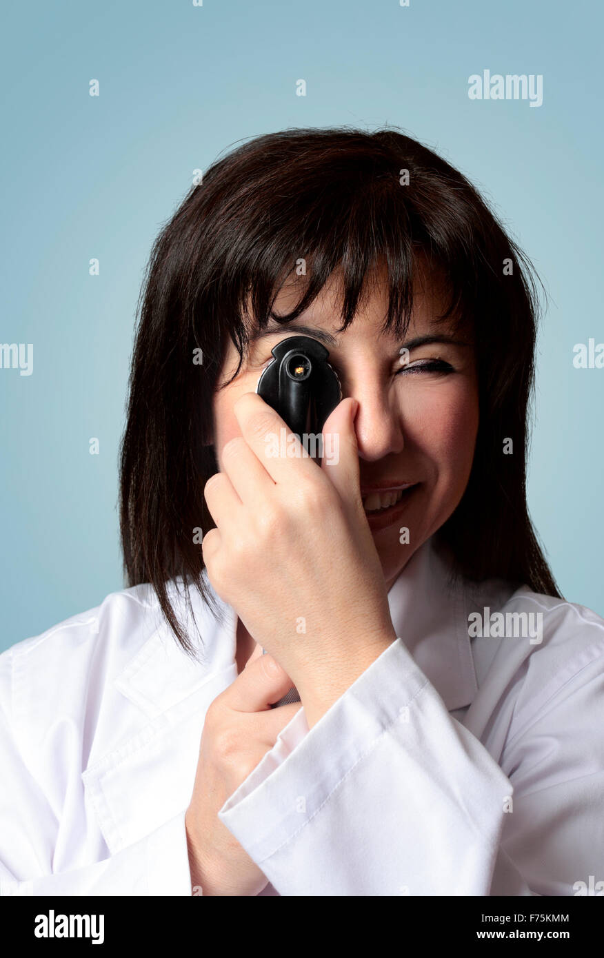 Eye doctor using opthalmoscope Stock Photo - Alamy