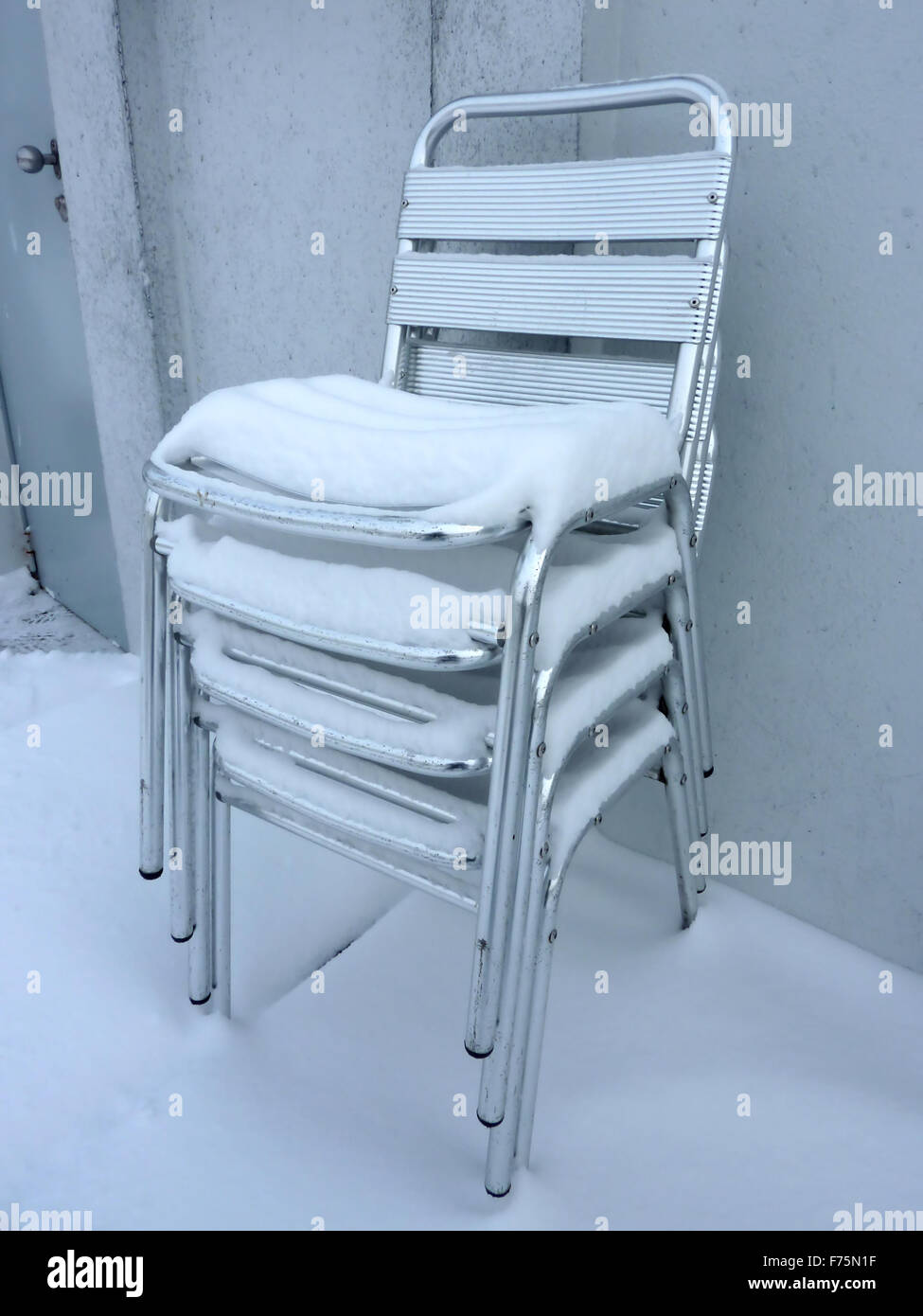 Pile of chairs covered by snow Stock Photo - Alamy