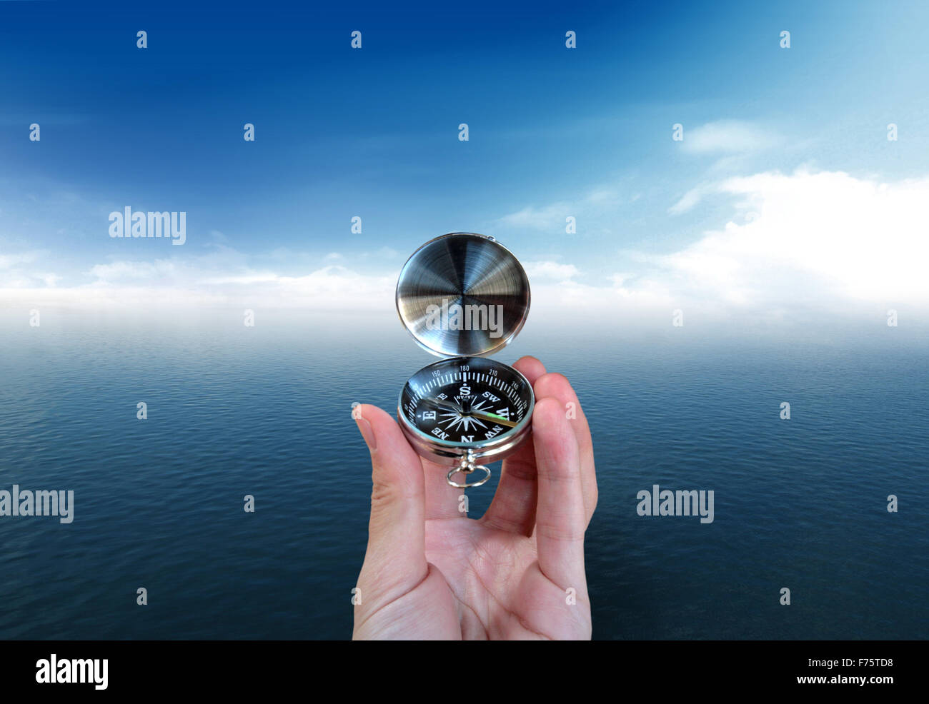 Compass and a hand Stock Photo - Alamy