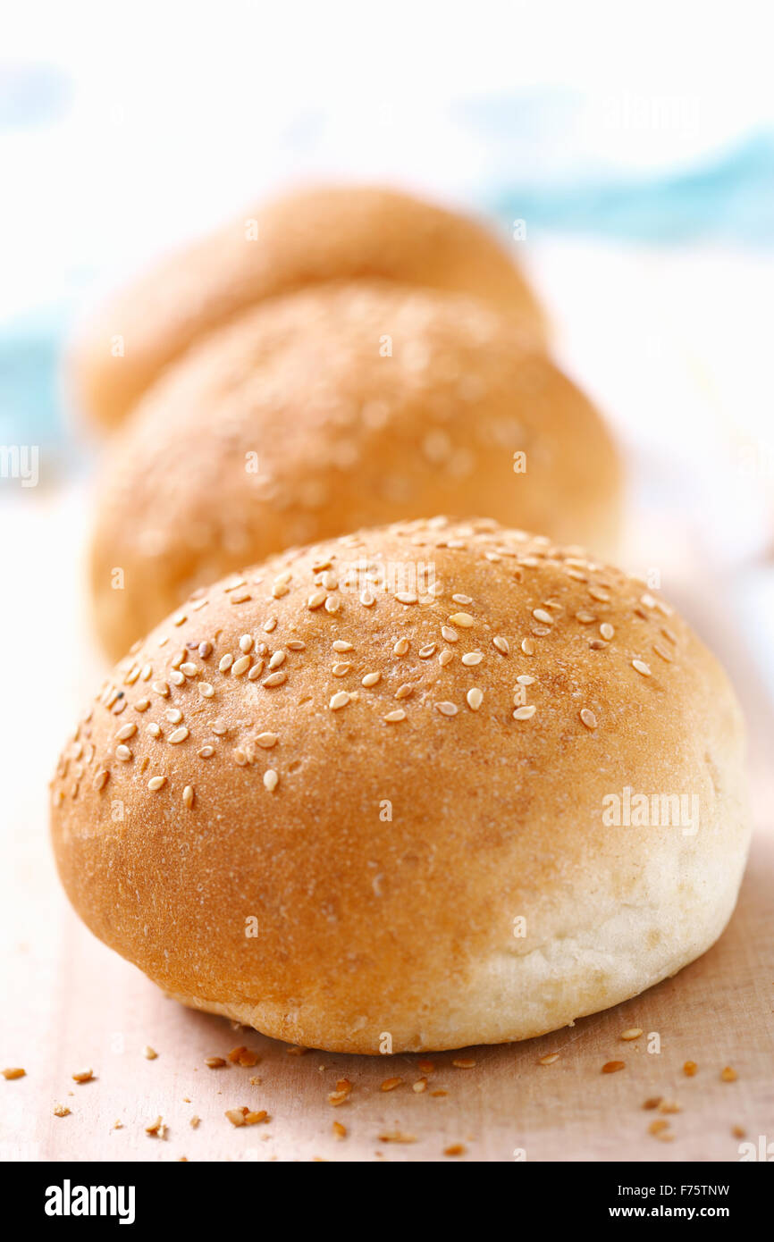Three wheat buns with sesame Stock Photo - Alamy