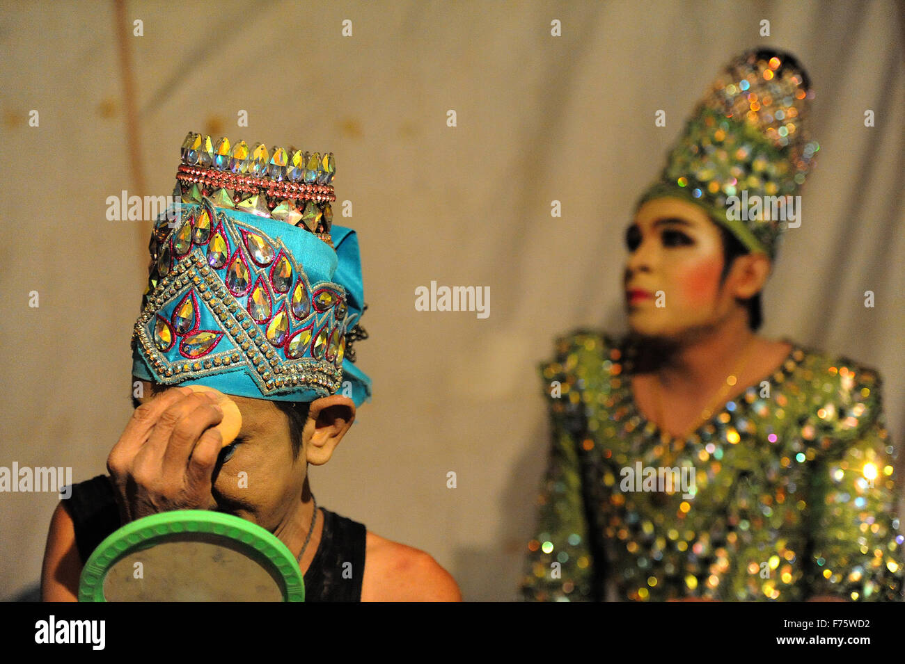 Bangkok, Thailand. 25th Nov, 2015. An actor puts on makeup at the ...