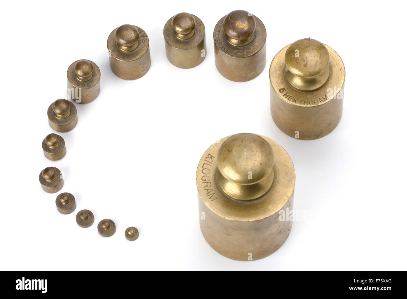 brass weights on white background Stock Photo - Alamy