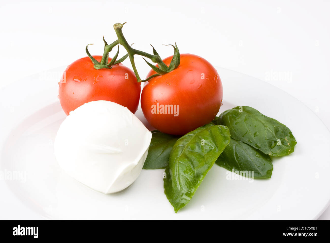 caprese: tomatoe, basil and mozarella cheese Stock Photo - Alamy