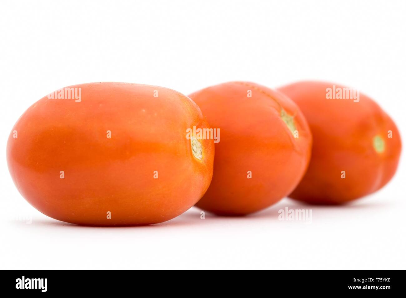 Three red tomatoes Stock Photo - Alamy