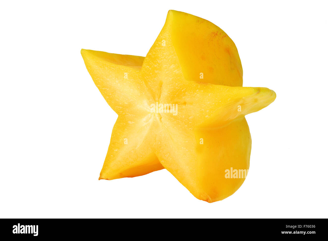 a single cut five star fruit on white background Stock Photo - Alamy
