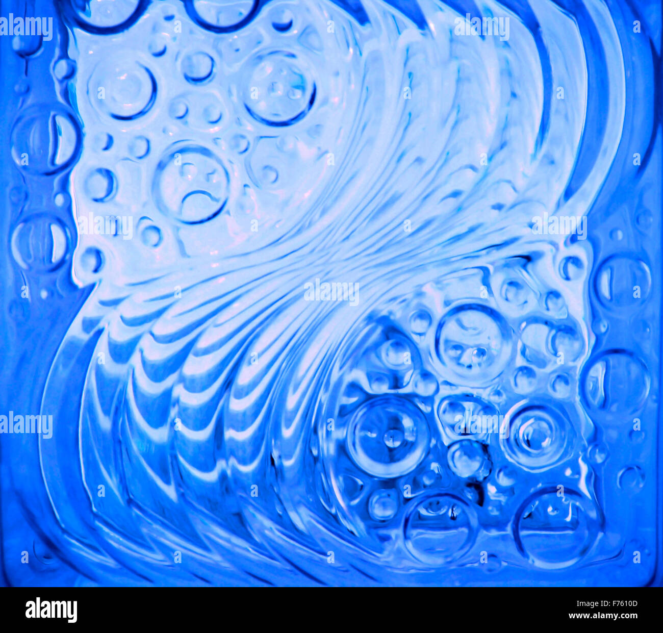 a bright blue glass tile with twirls and bubbles Stock Photo - Alamy