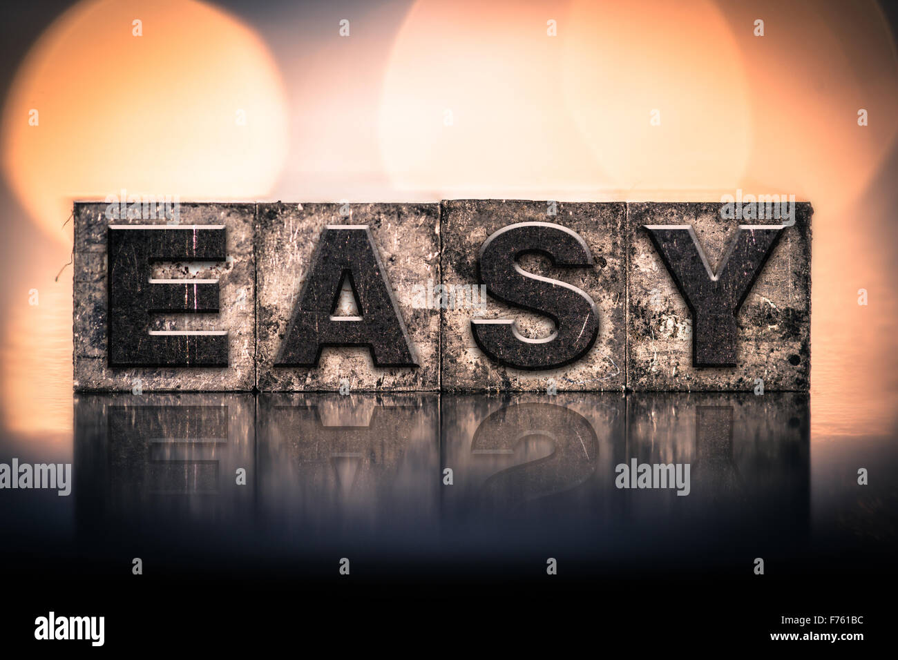 The word "EASY" written in vintage ink stained letterpress type Stock ...