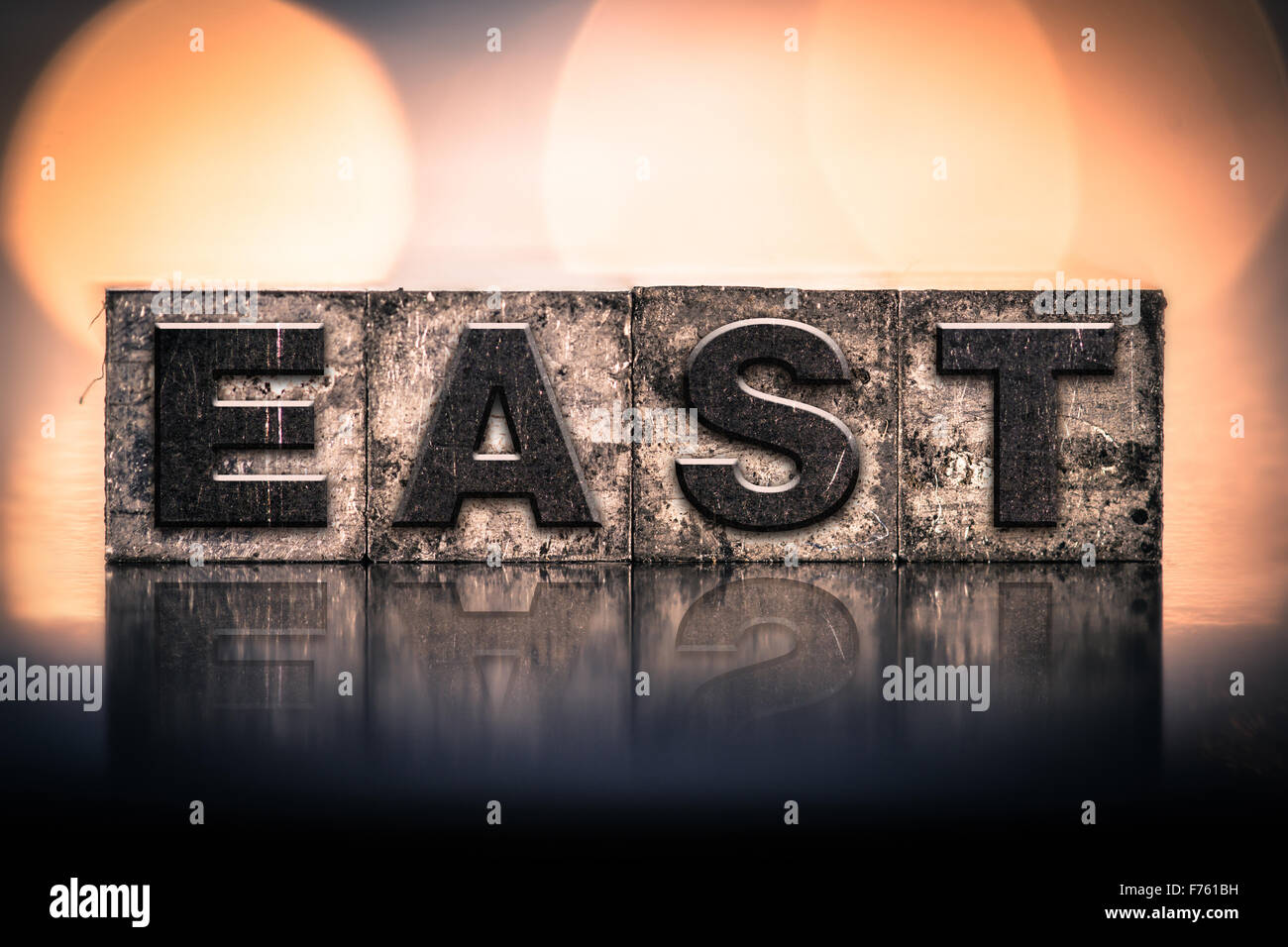 The word "EAST" written in vintage ink stained letterpress type Stock ...