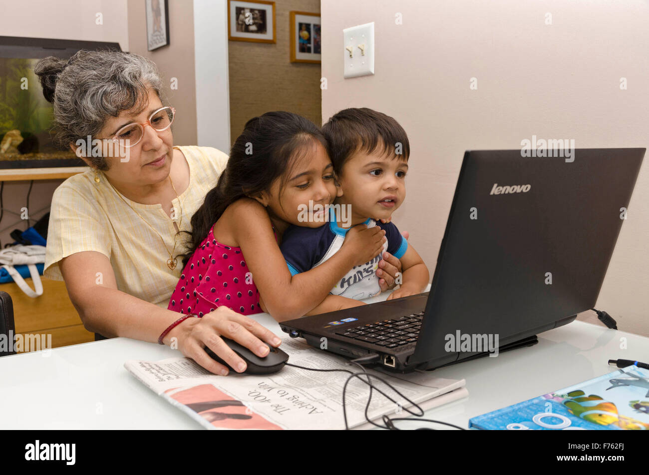 grandmother teaching children learning on laptop computer with granny ...