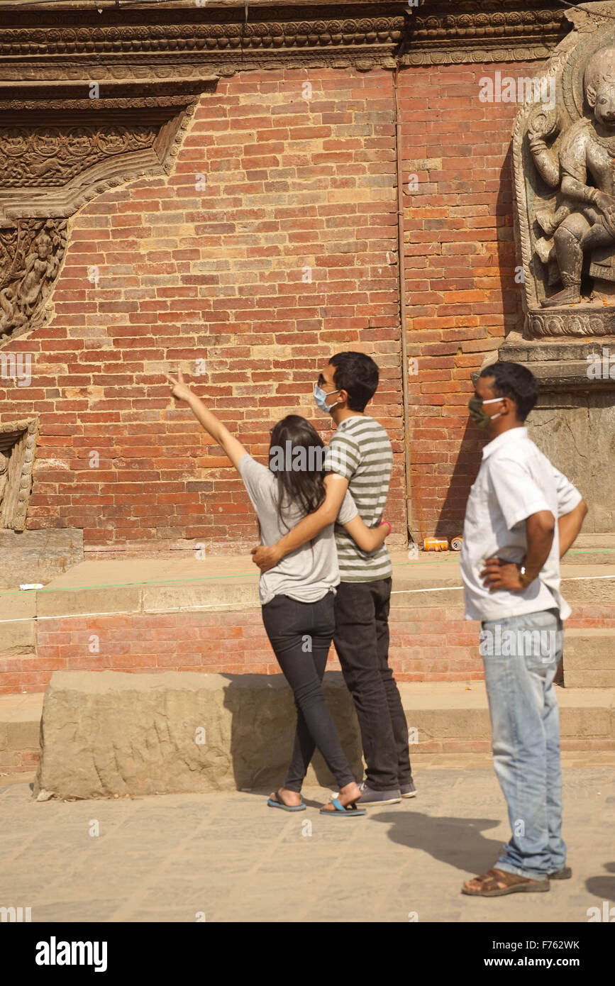 Couple watching damaged, krishna temple, nepal, asia Stock Photo - Alamy