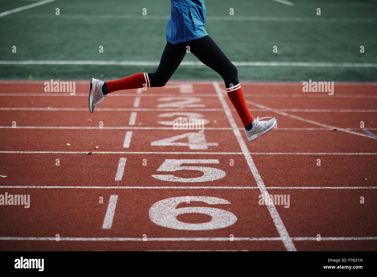 Runner running on a stadium Stock Photo - Alamy