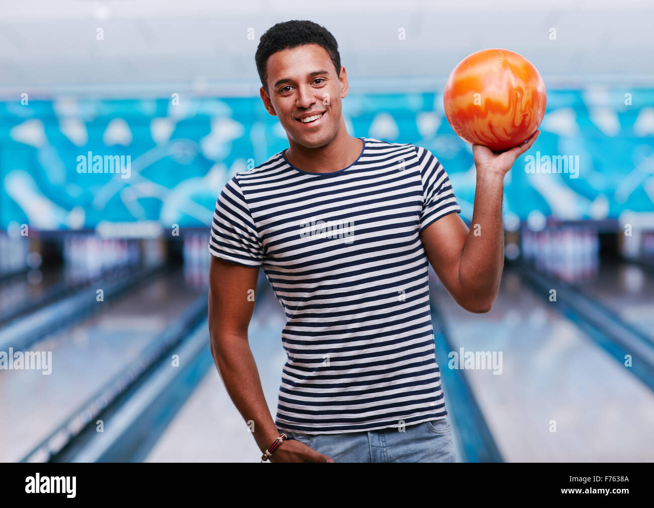 Young guy playing in bowling Stock Photo - Alamy
