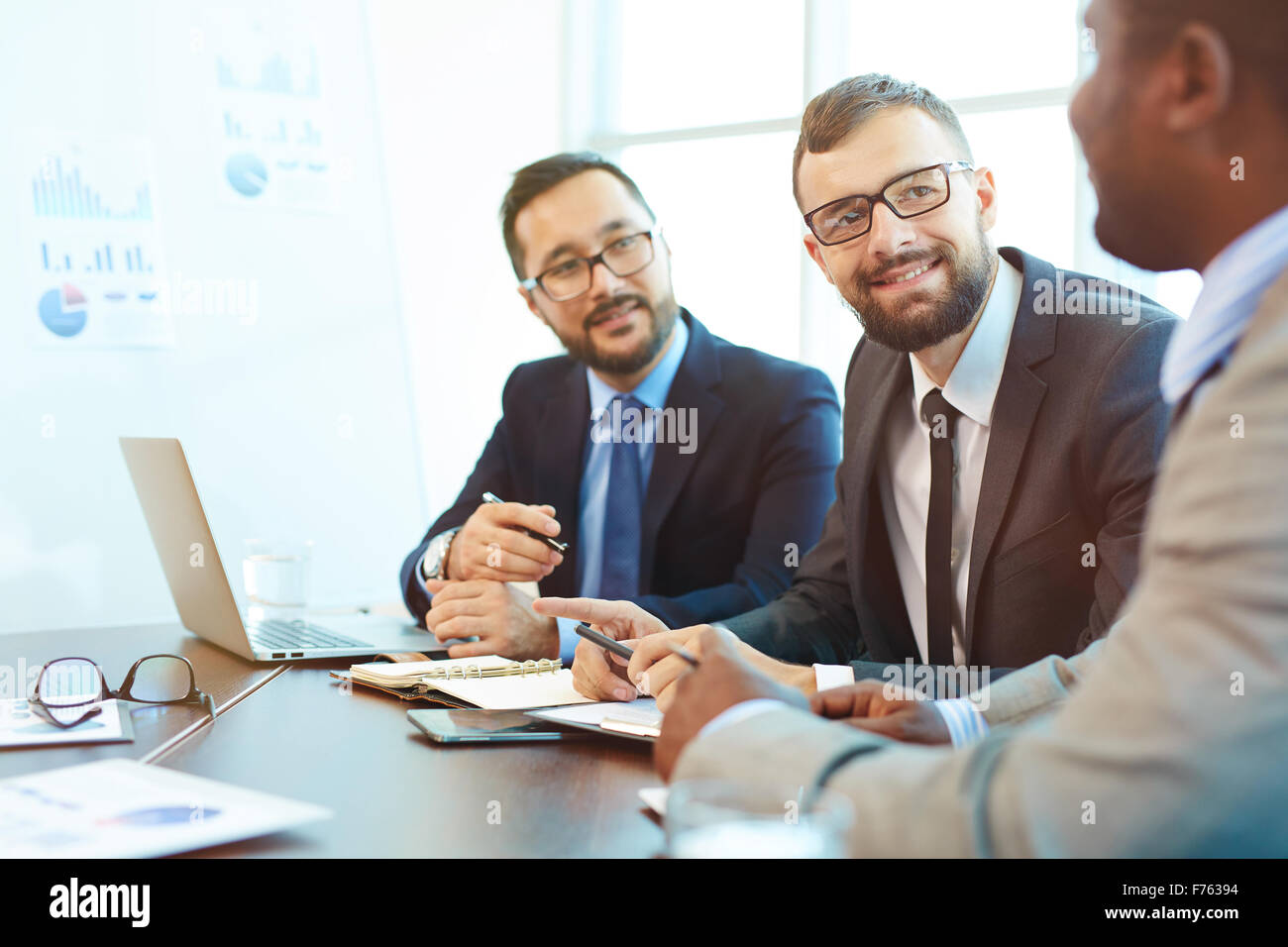 Multi-ethnic group of businessmen planning work Stock Photo - Alamy
