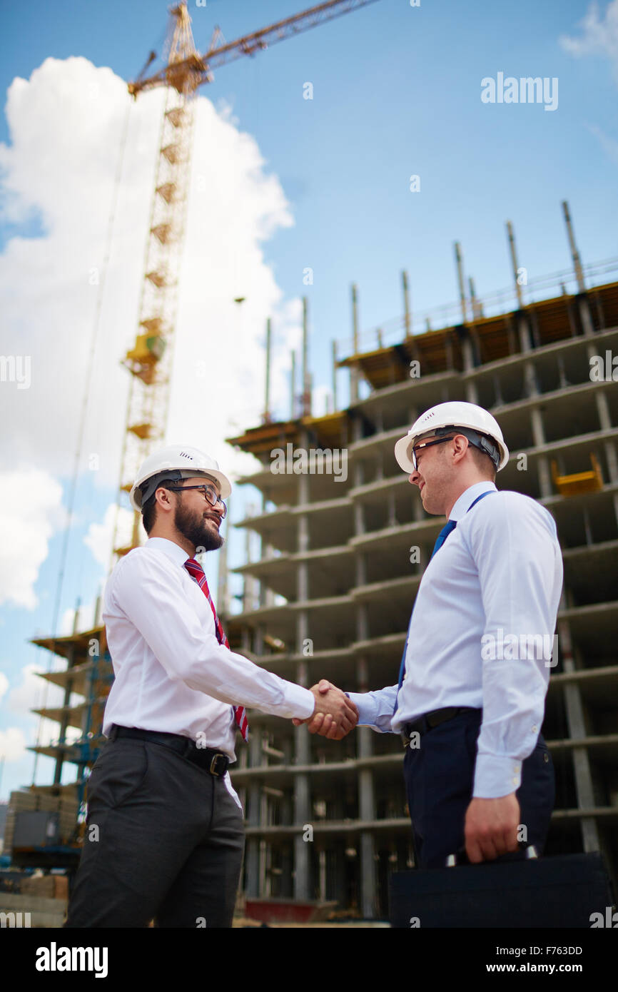 Young architects or builders handshaking after making agreement Stock ...