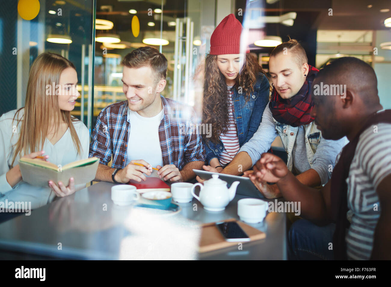 Teenage friends doing homework in cafe Stock Photo - Alamy