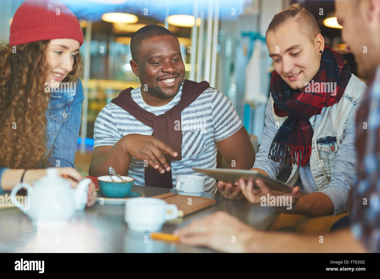 Gadget addicted teenagers with touchpad sitting in cafe Stock Photo - Alamy