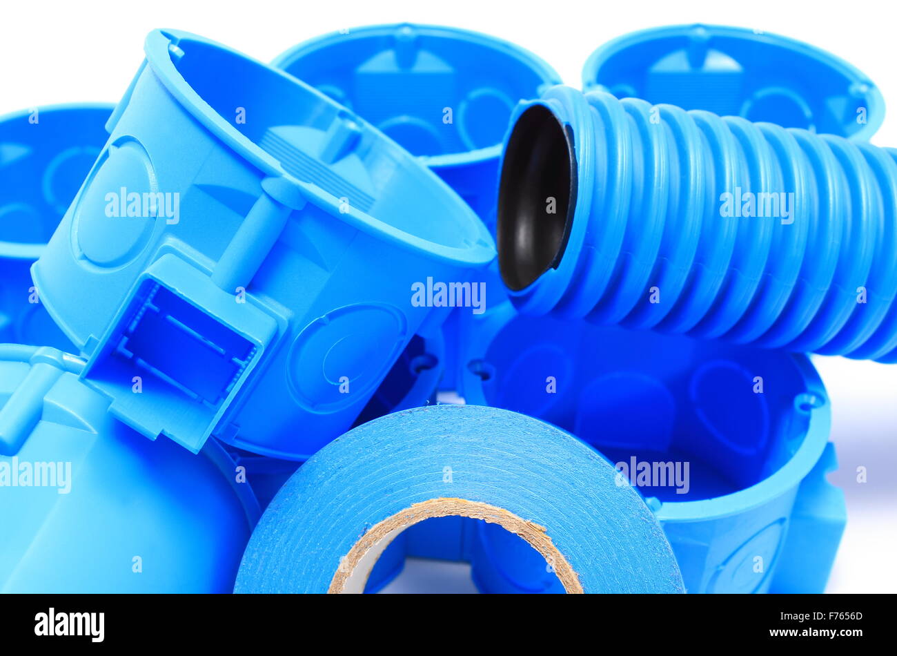 Heap of blue electrical boxes and components for use in electrical ...