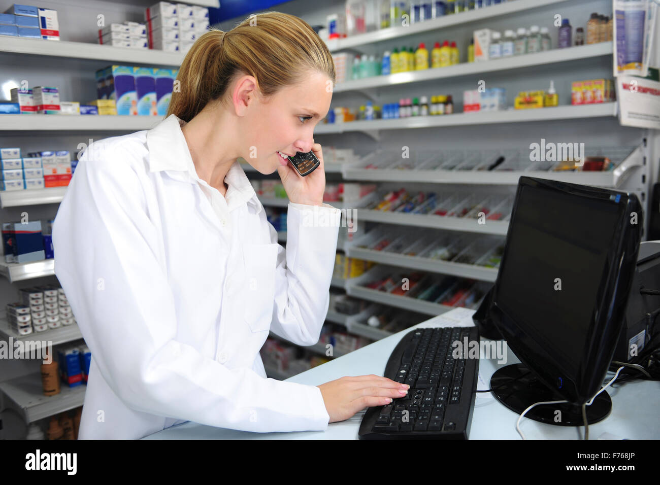 pharmacist using computer and telephone Stock Photo - Alamy