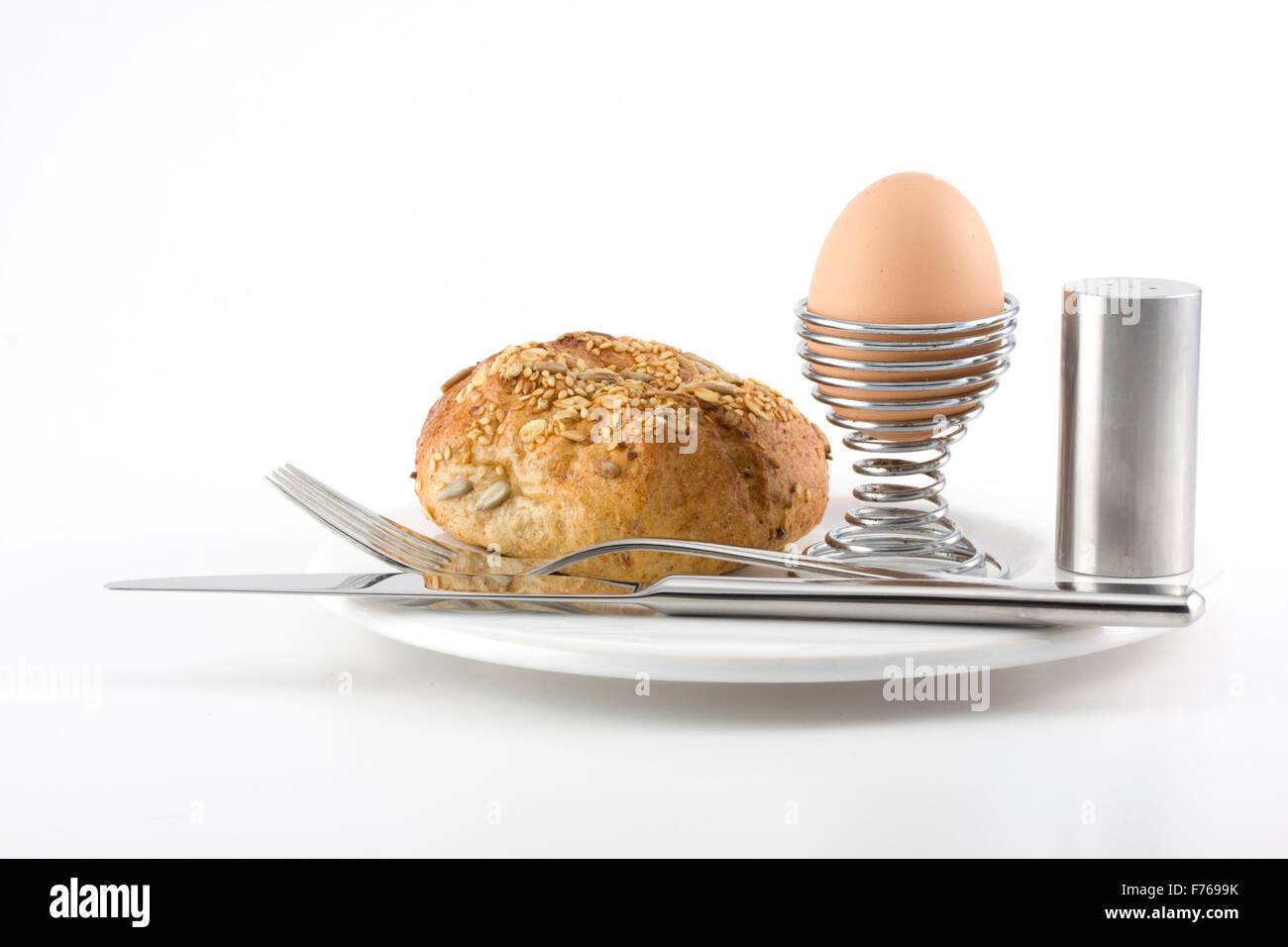 bun, egg, cutlery and a white plate Stock Photo - Alamy