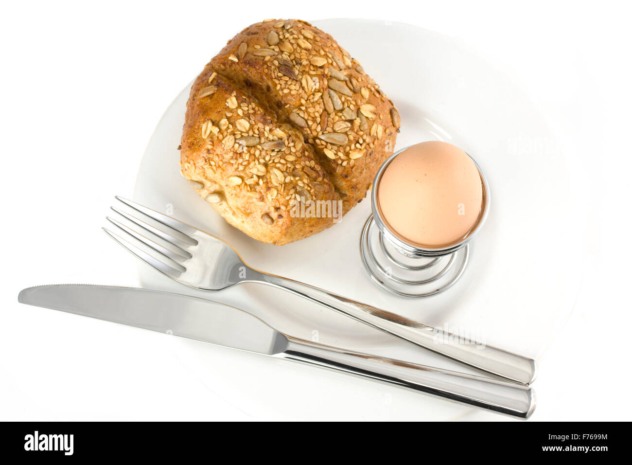 bun, egg, cutlery and a white plate Stock Photo - Alamy
