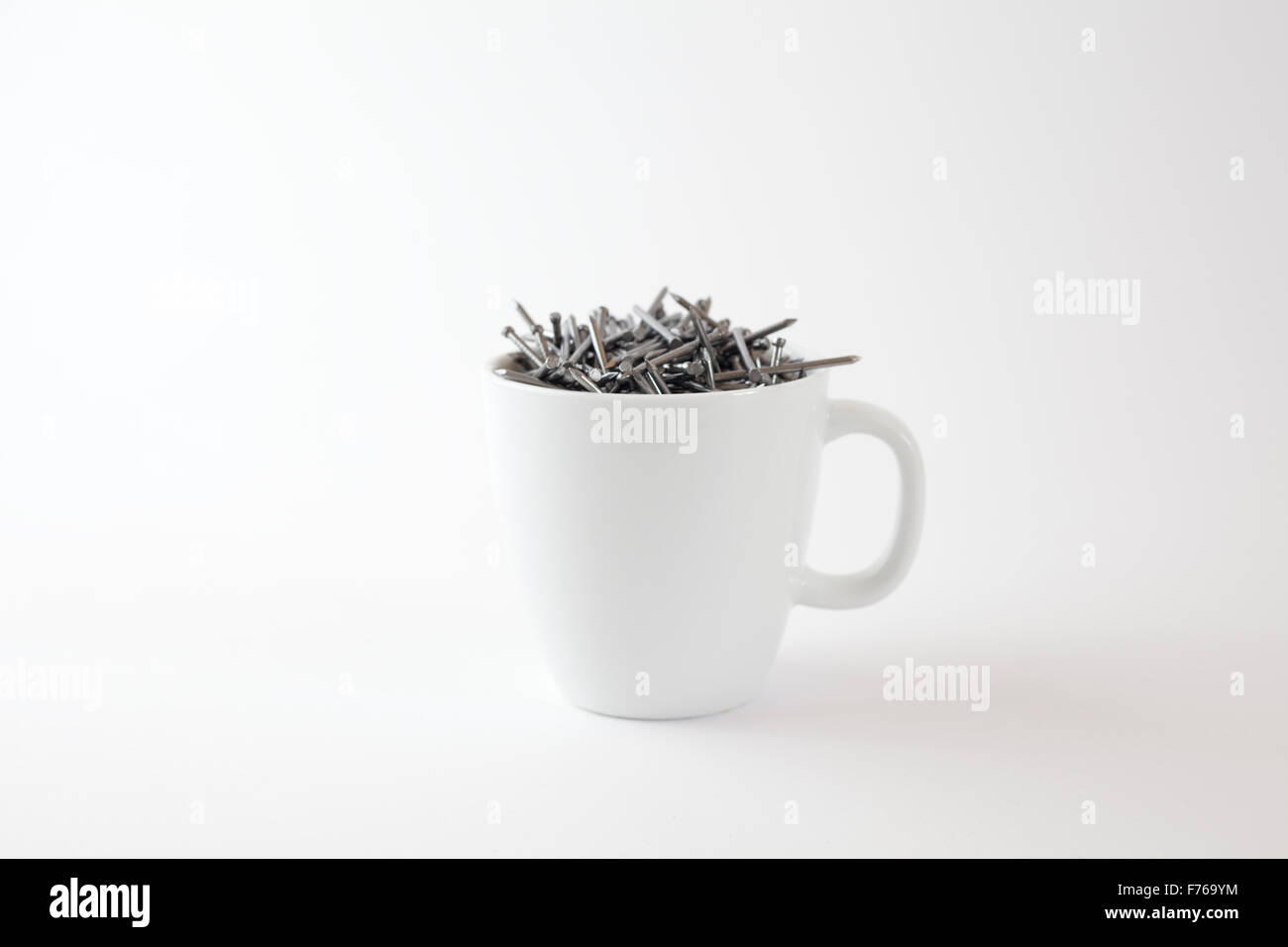 Coffee Cup of Straight Nails Stock Photo - Alamy