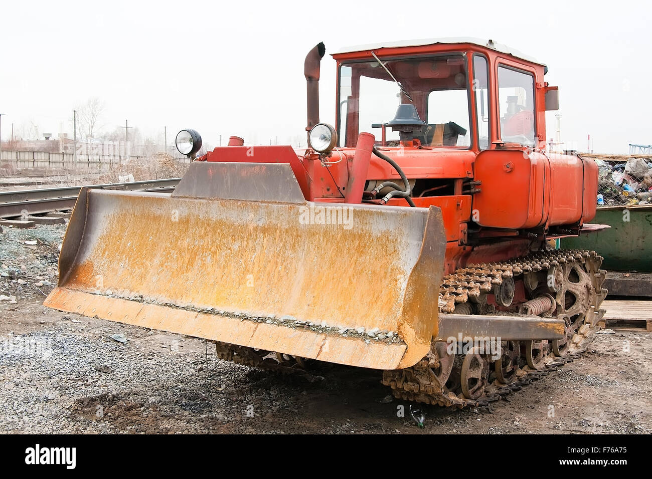 Bulldozer is red with a raised bucket without people Stock Photo - Alamy