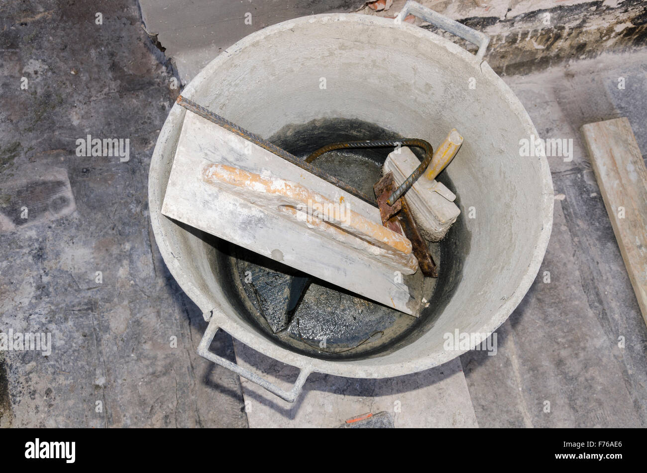 tools and cement in a bucket at a construction site Stock Photo - Alamy