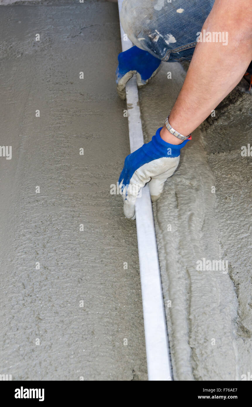 rigone to smooth the concrete on a building site Stock Photo - Alamy