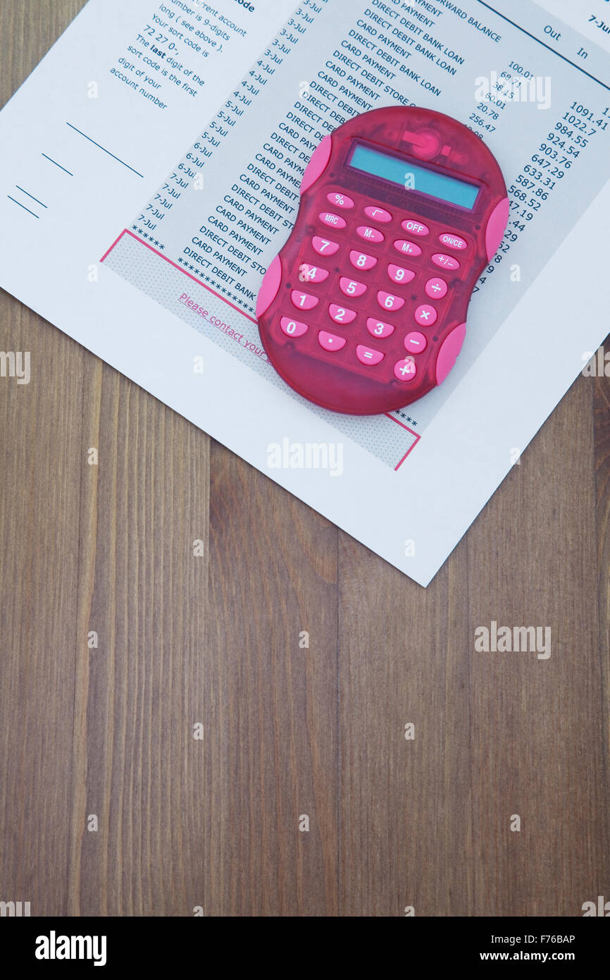 Calculator on a Bank statement and credit card statement on a Wo Stock ...